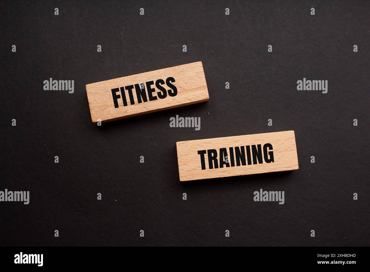 Fitness training message written on wooden blocks with black background ...