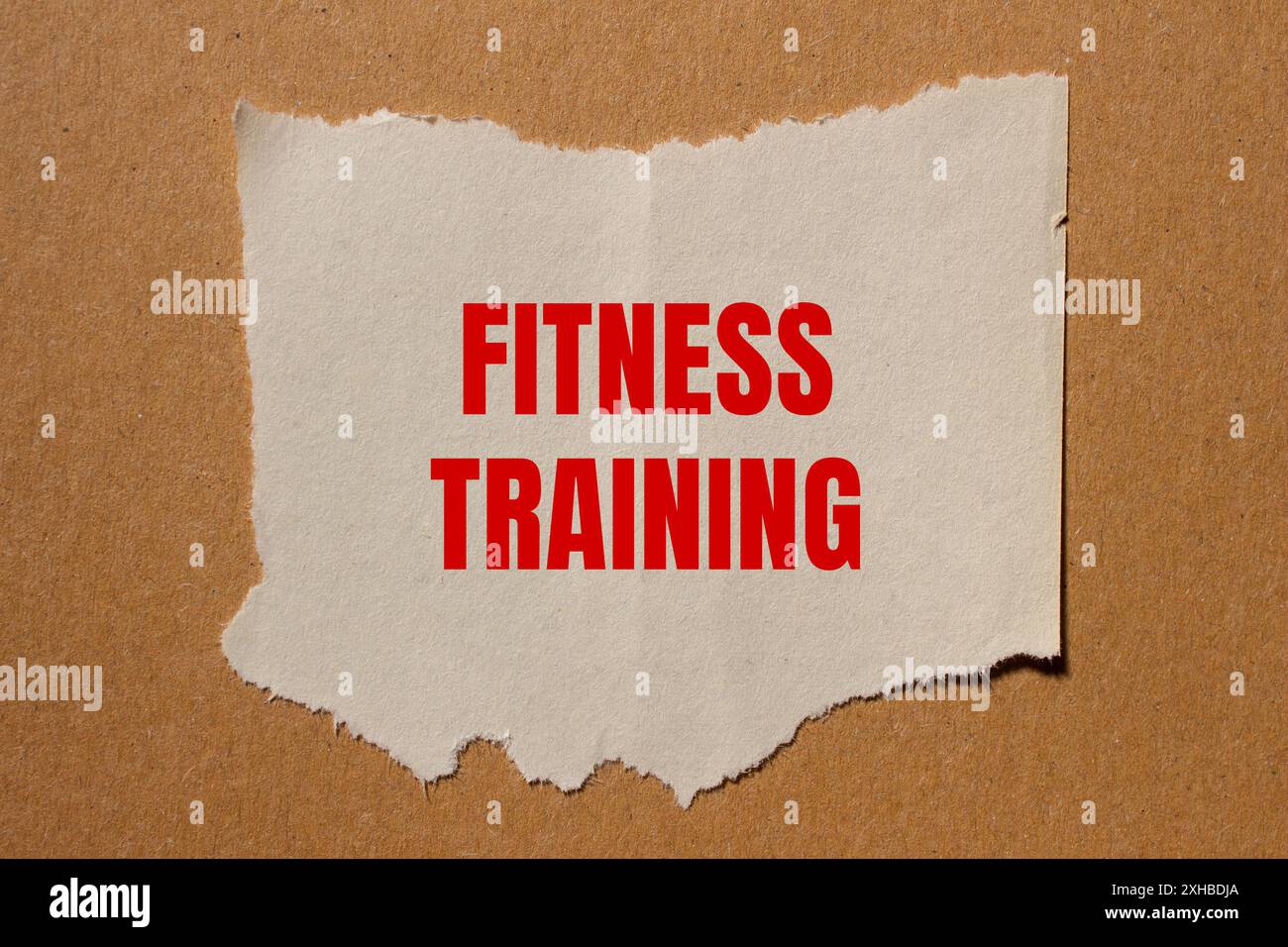 Fitness training message written on ripped paper with cardboard ...