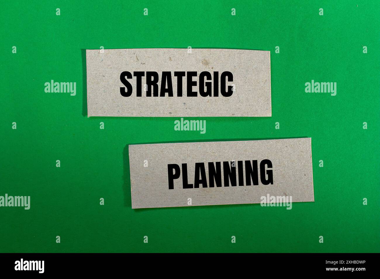 Strategic planning message written on paper pieces with green ...