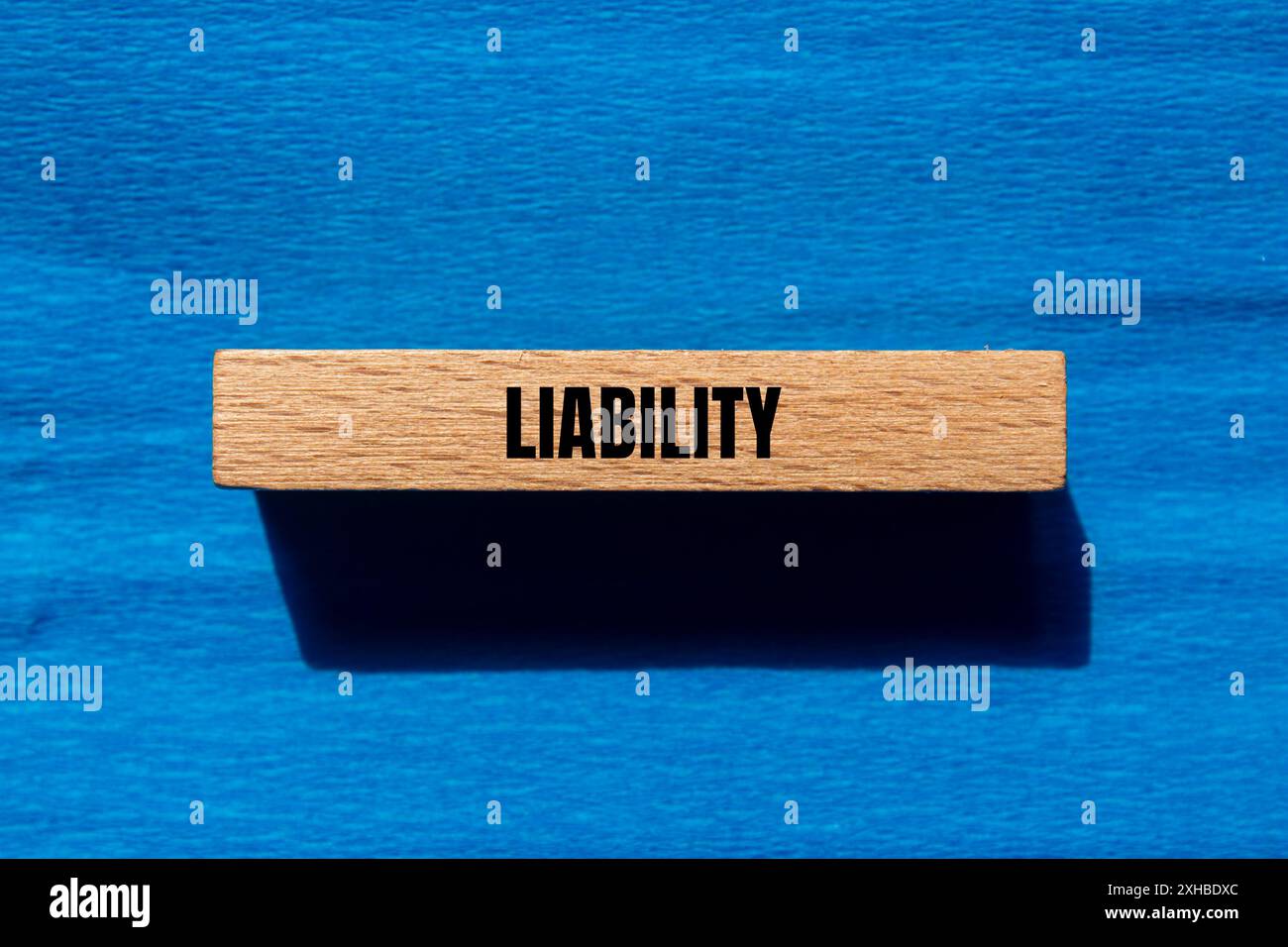 Liability message written on wooden block with blue background ...