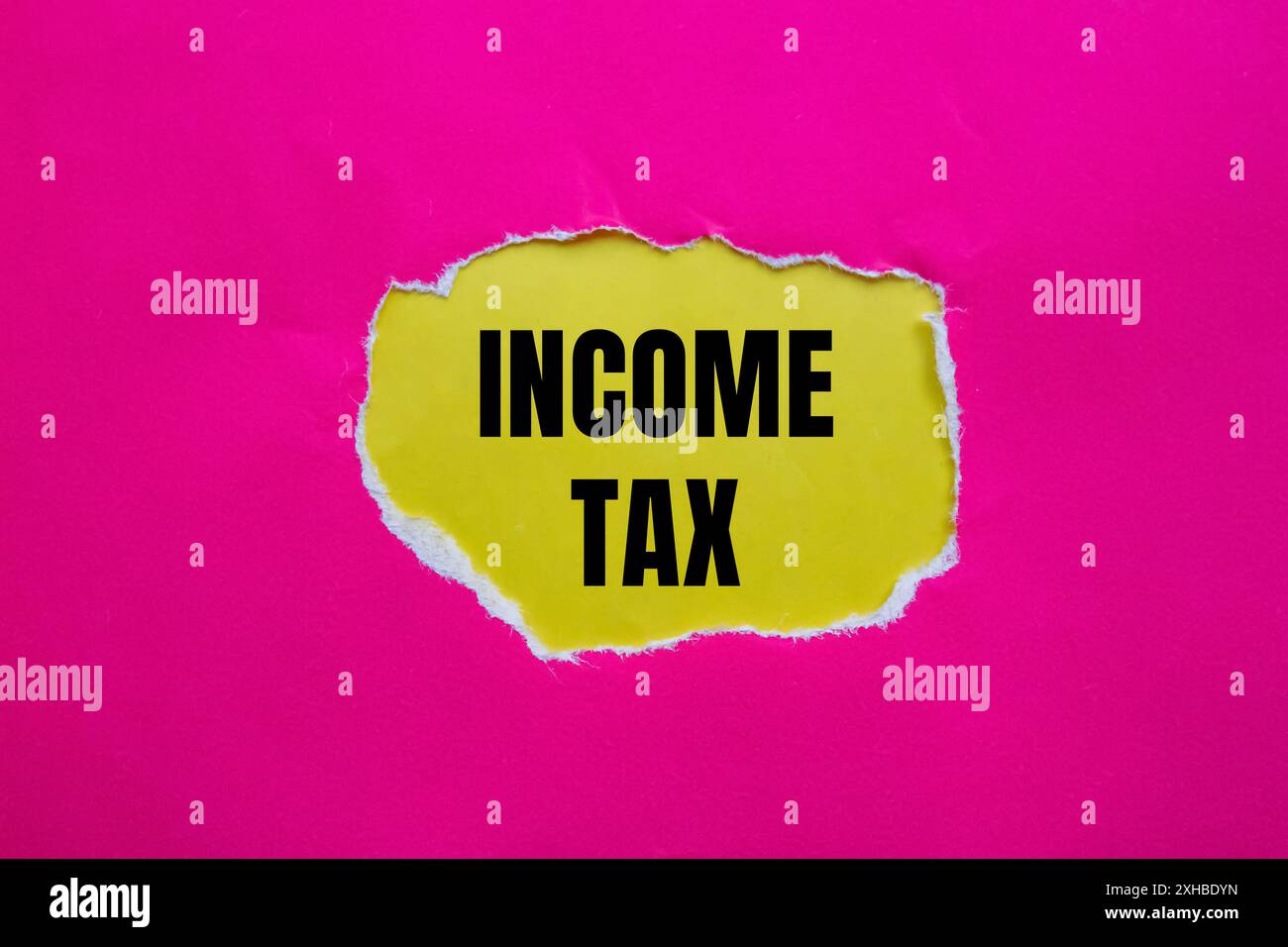 Income tax words written on ripped pink paper with yellow background ...