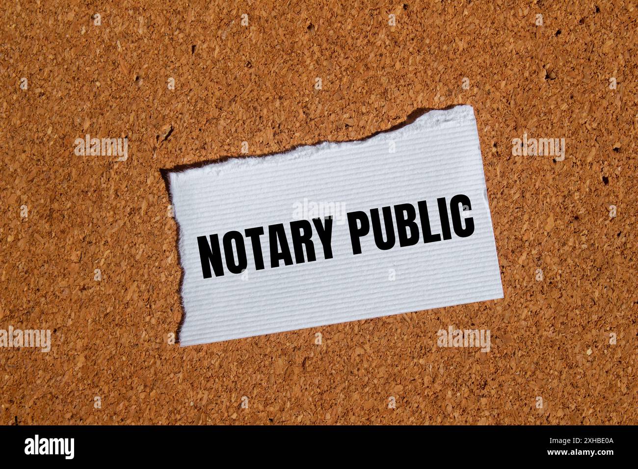 Notary public words written on ripped white paper with brown background ...