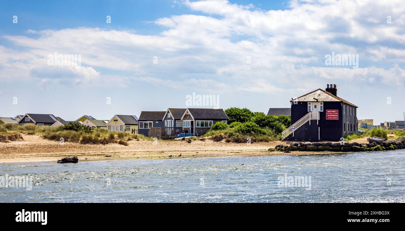 The Black House and beach huts on Mudeford Spit from Mudeford Quay ...