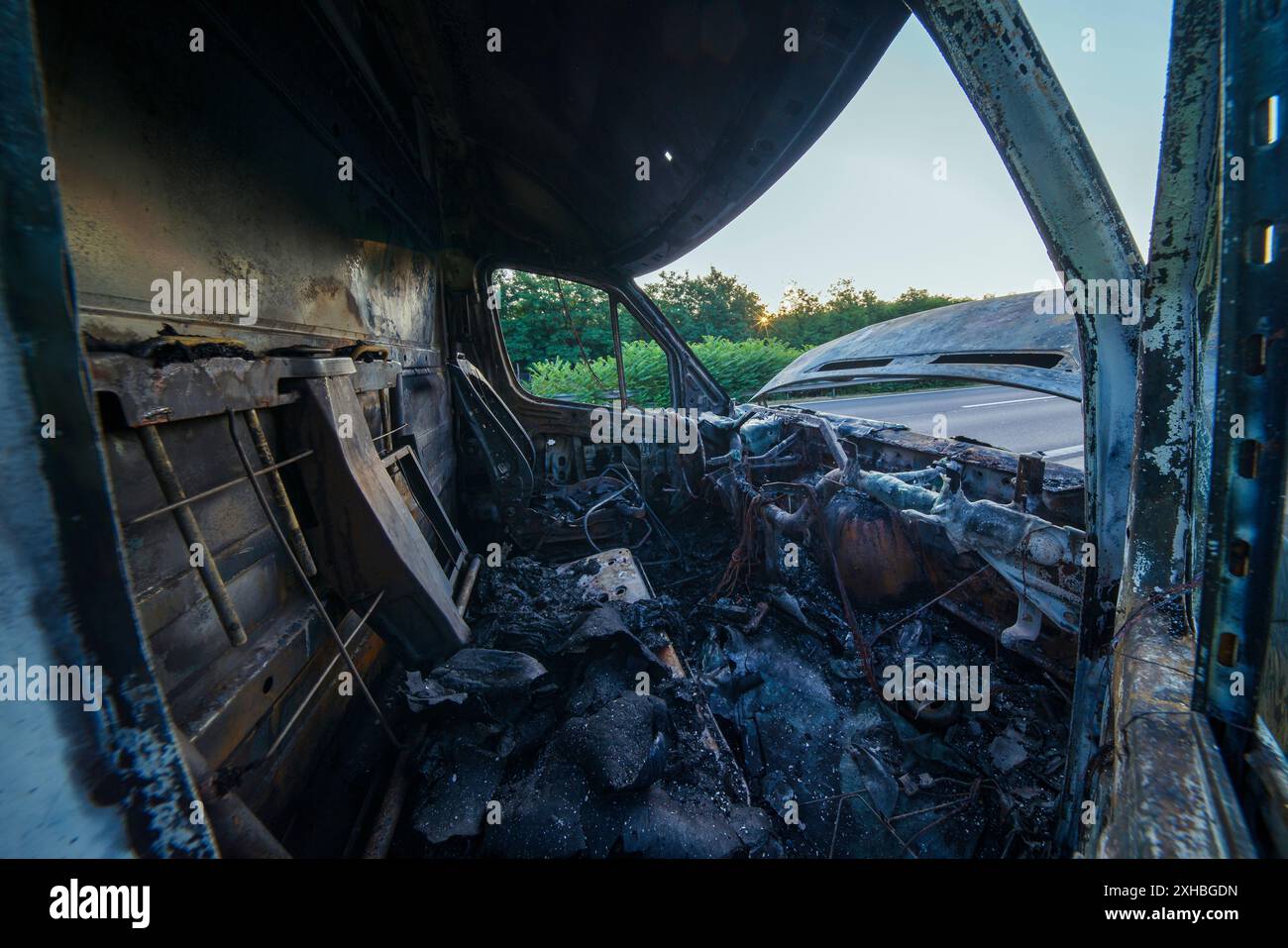 A burnt-out car on the highway. It’s a total loss, unusable, a wreck ...