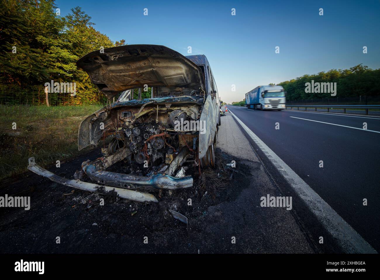 A burnt-out car on the highway. It’s a total loss, unusable, a wreck ...
