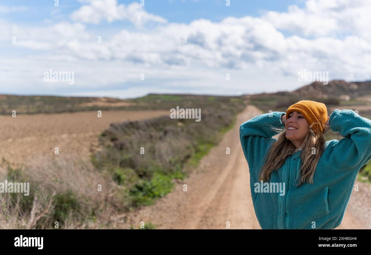 Woman happy and smiling with open arms on the road. Travel, adventure ...