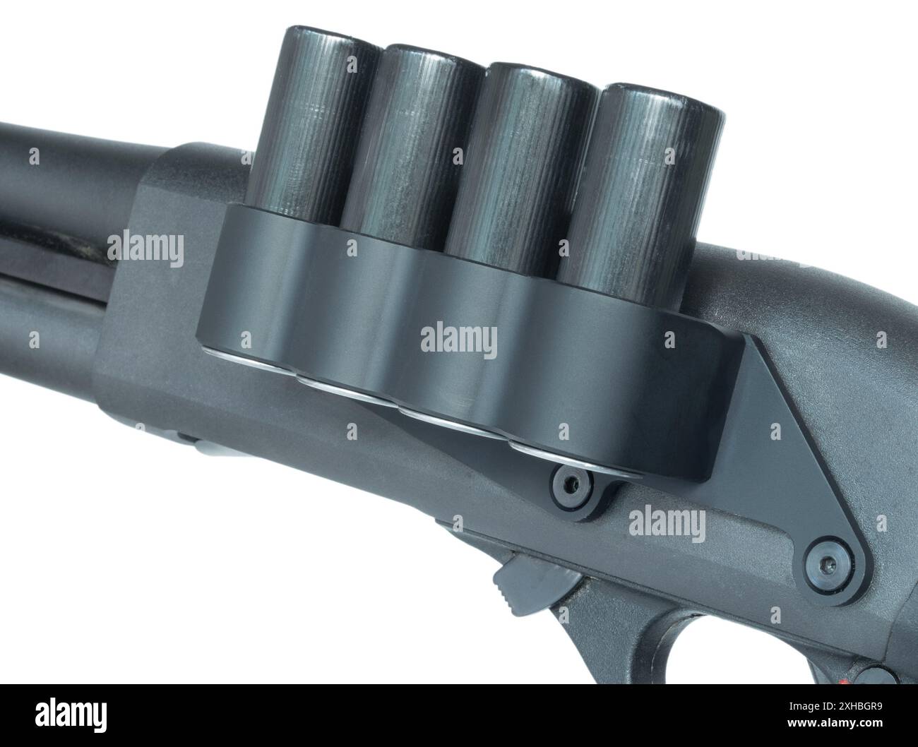 Isolated pump action shotgun with four spare rounds riding in a ...