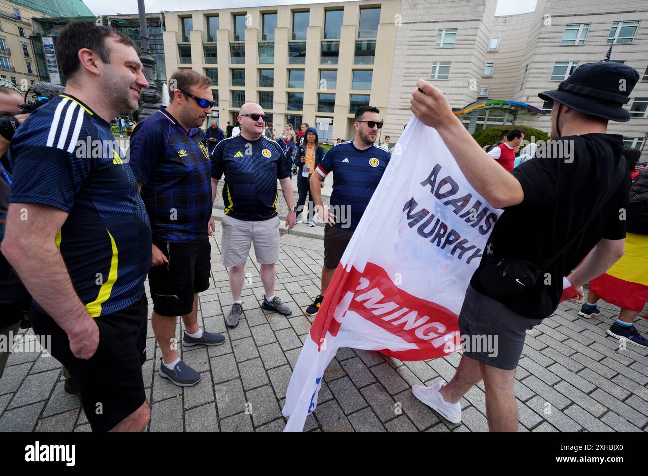 An England fan (right) speaks with Scotland fans as they gather next to ...
