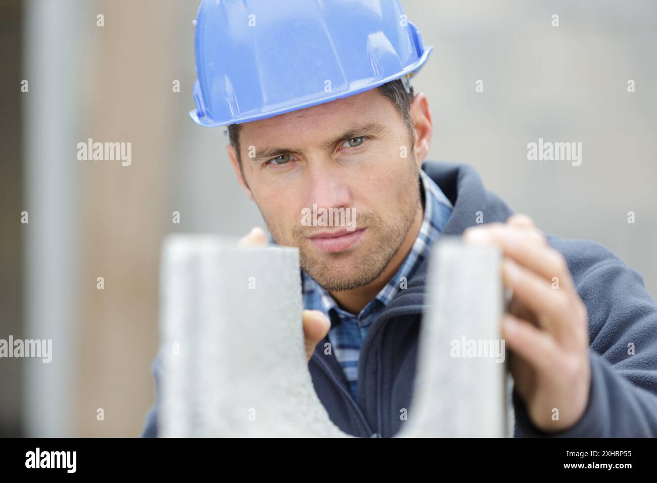 man bricklayer is checking brick block cement Stock Photo - Alamy