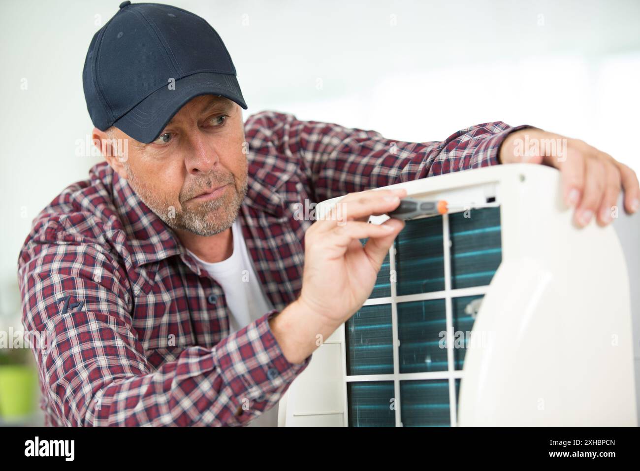 man trying to repair the air conditioning Stock Photo - Alamy