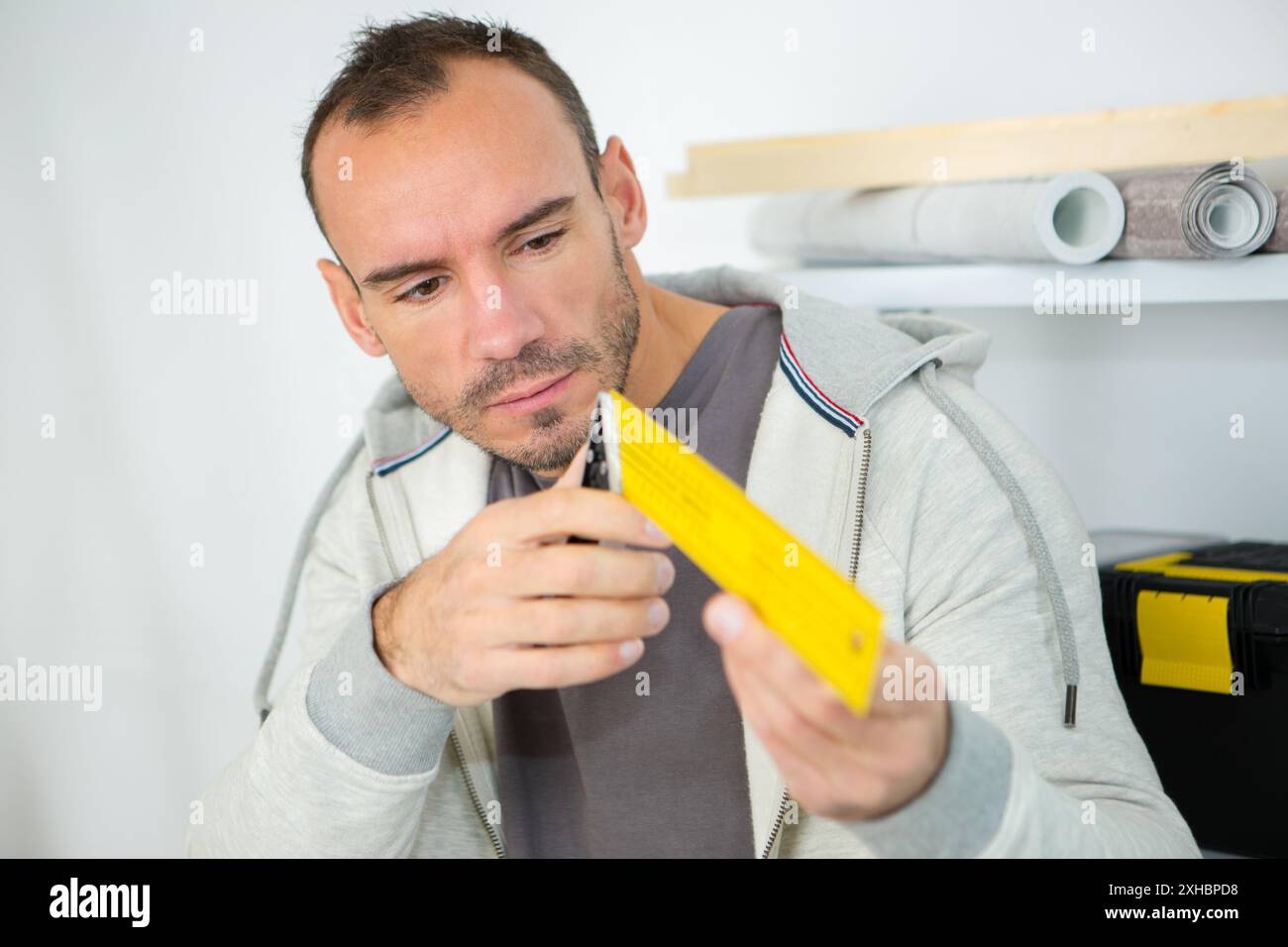 a man measuring with tape Stock Photo - Alamy