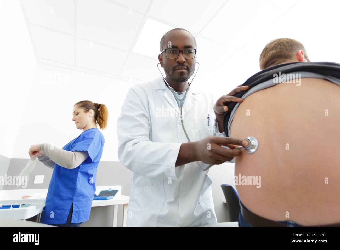 Doctor listening patients back stethoscope hi-res stock photography and ...