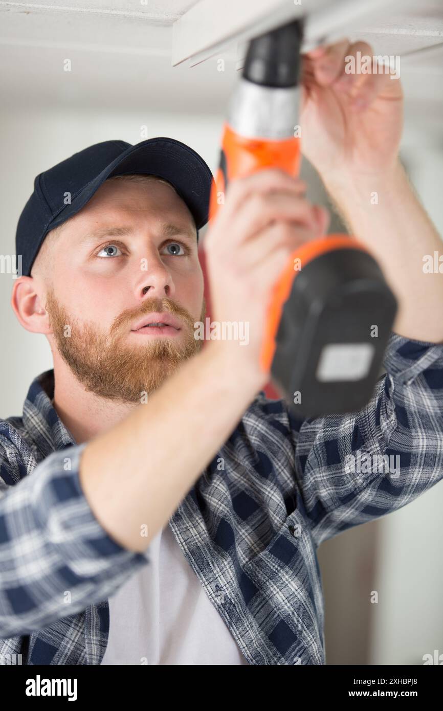 Worker drilling ceiling perforator hi-res stock photography and images ...