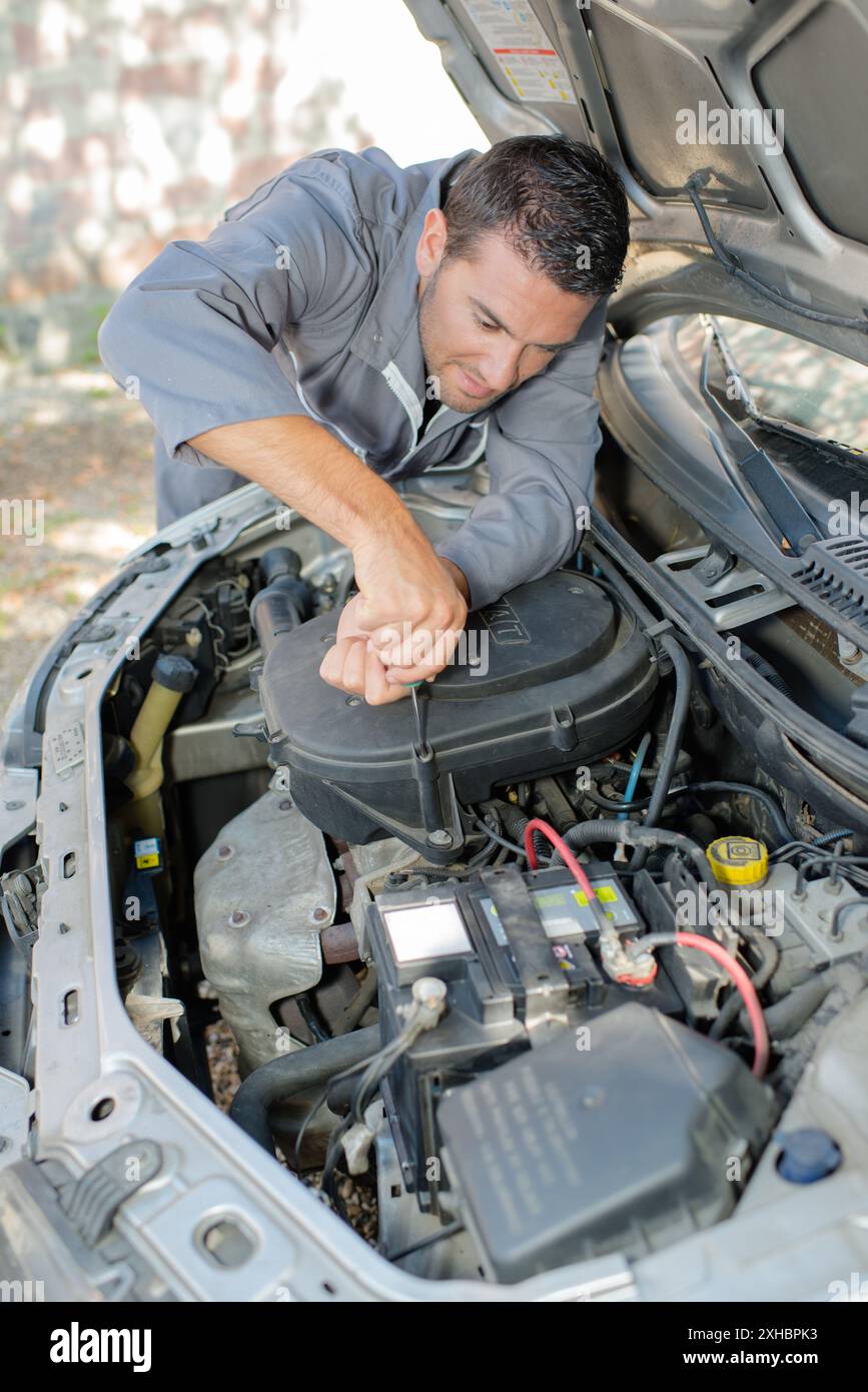 Man fixing a car engine Stock Photo - Alamy