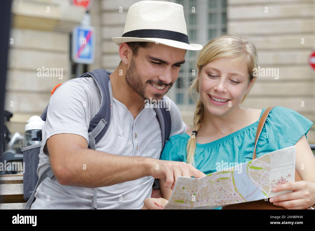 man with map shows the girl a direction Stock Photo - Alamy