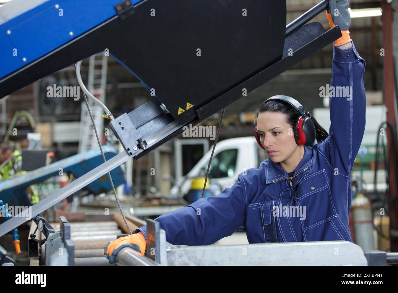 female factory worker inspecting production line Stock Photo - Alamy