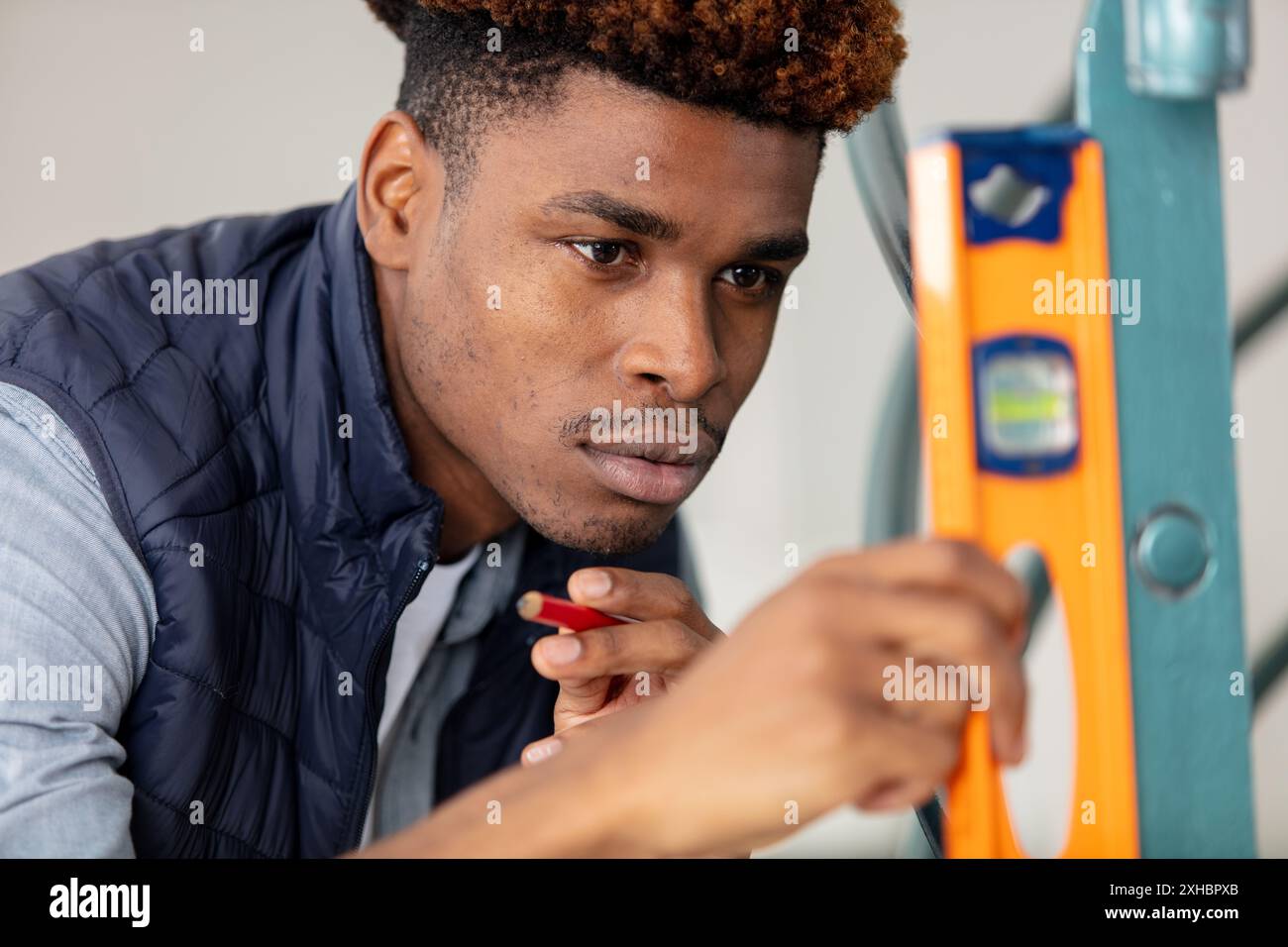 construction worker using spirit level in a new house Stock Photo - Alamy
