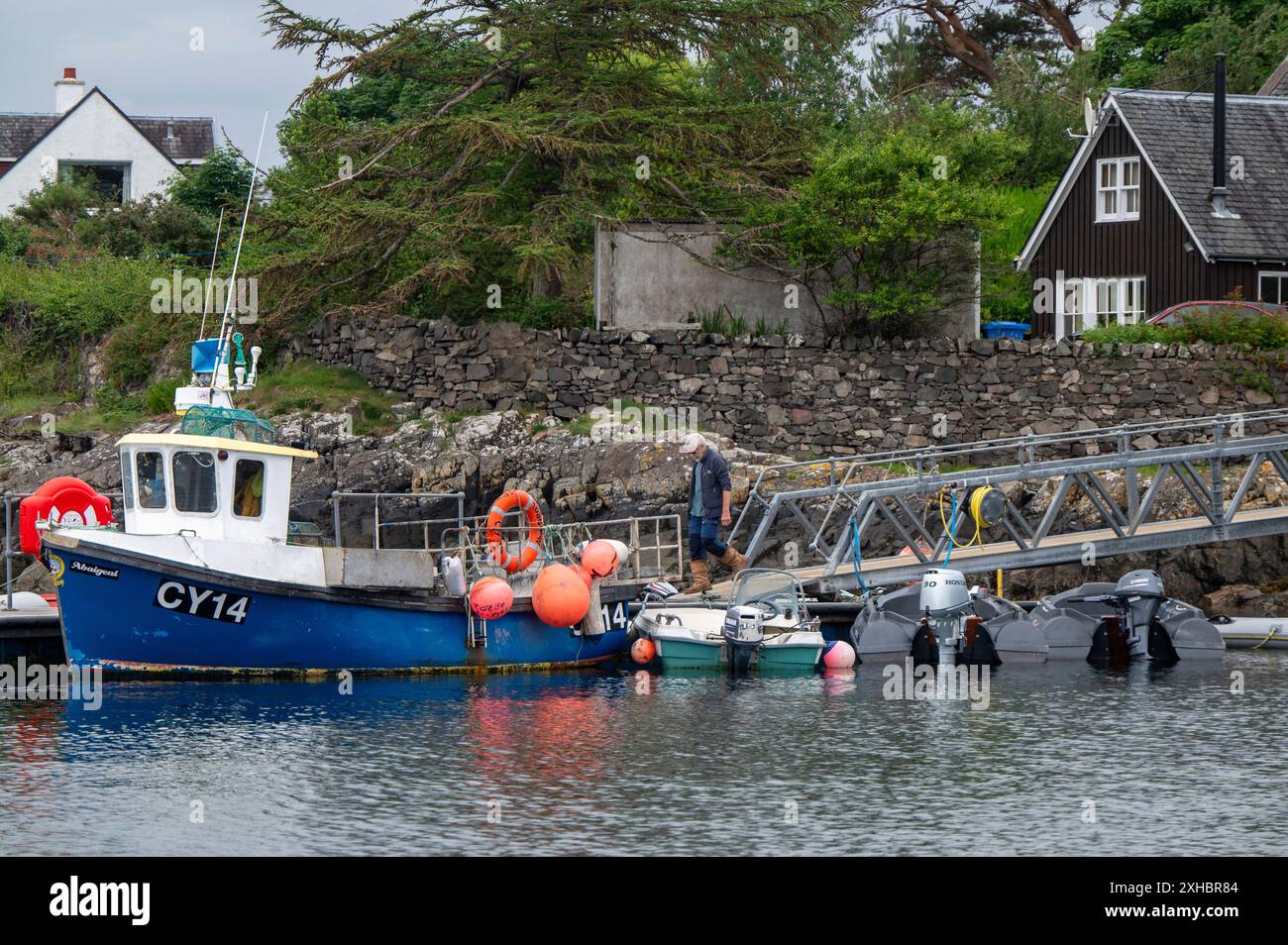 Scottish Highlands, Scotland, 2024 A small fishing boat moored on a ...
