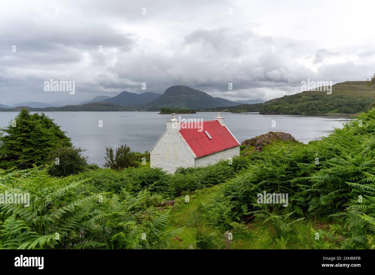 Scottish Highlands, Scotland, 2024 A small cottage looking across Loch ...