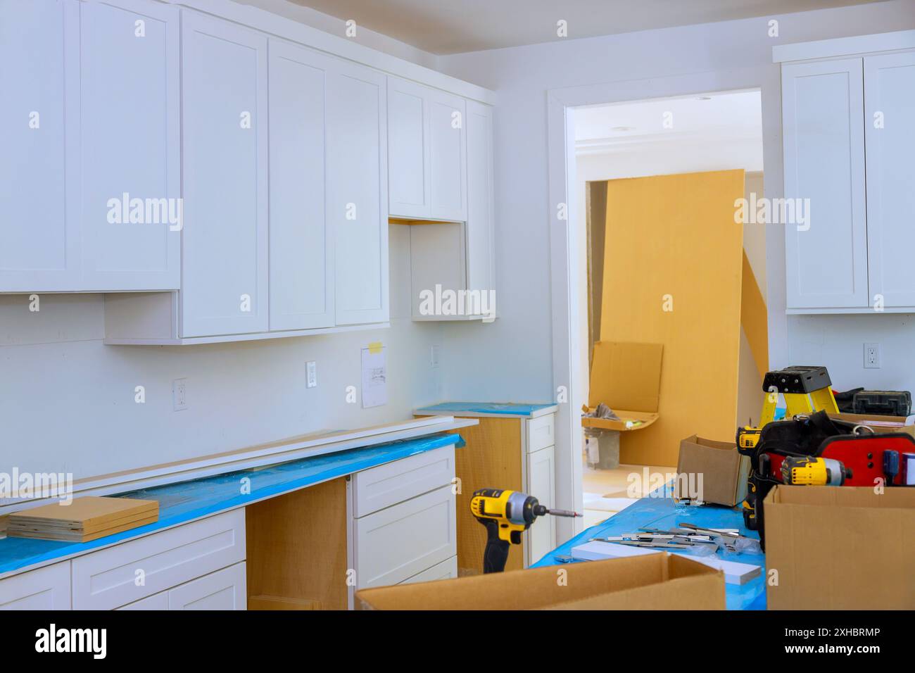 Assembling new custom made kitchen cabinet as part of Stock Photo - Alamy