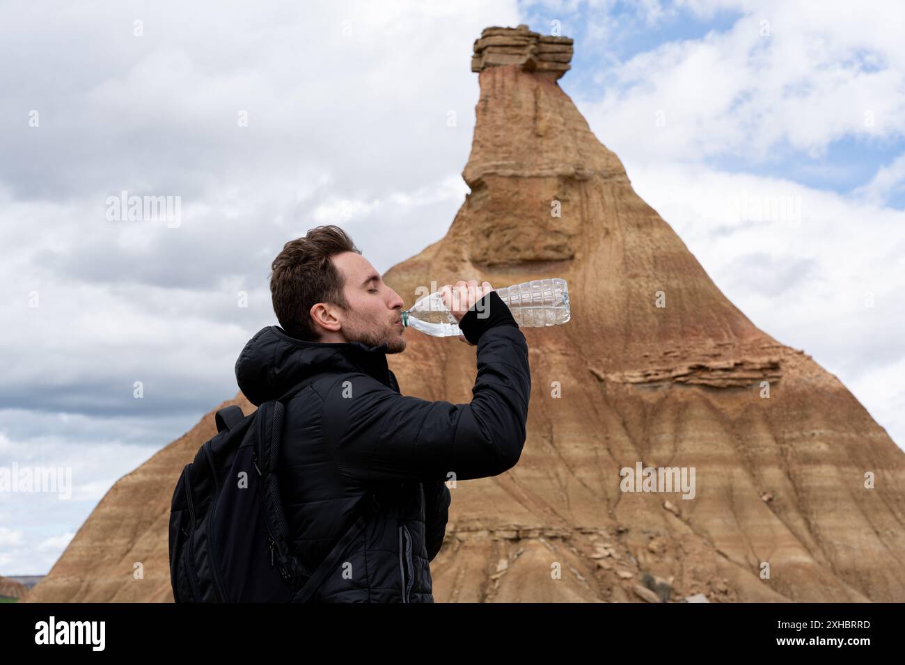 Adventurous man drinking water Stock Photo - Alamy