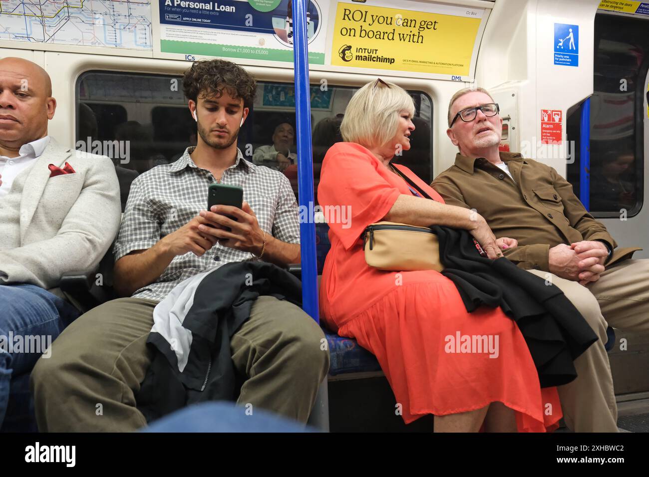 London UK passengers on a London Underground tube train in July 2024 ...