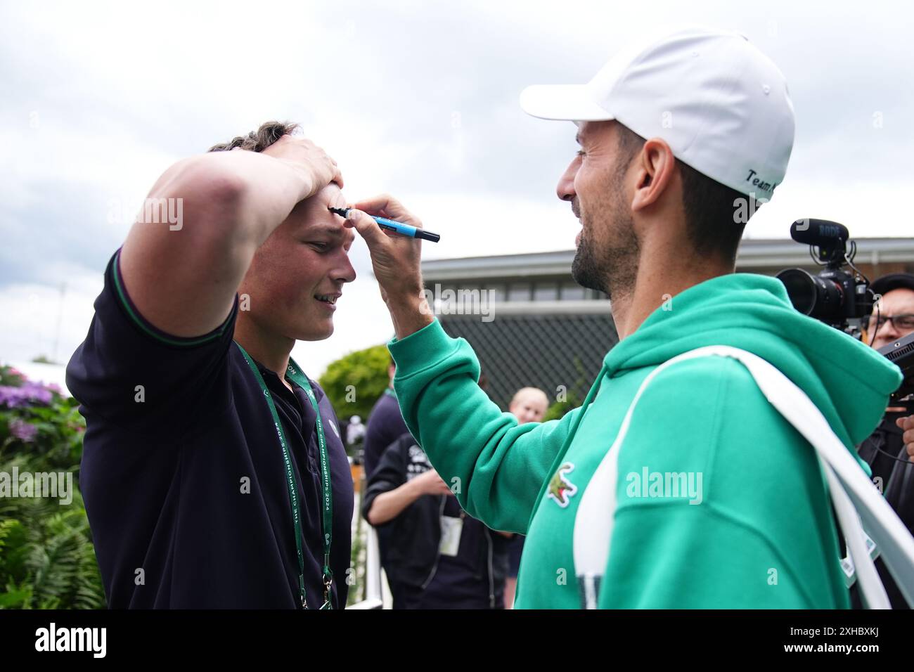Novak Djokovic signs fans forehead as he makes his way to training on ...