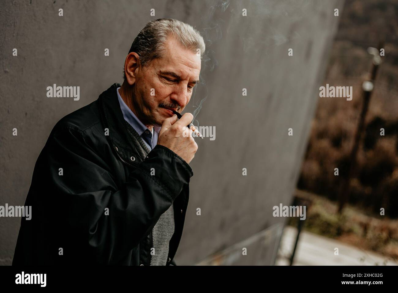 Senior male smoking cigarette hi-res stock photography and images - Alamy