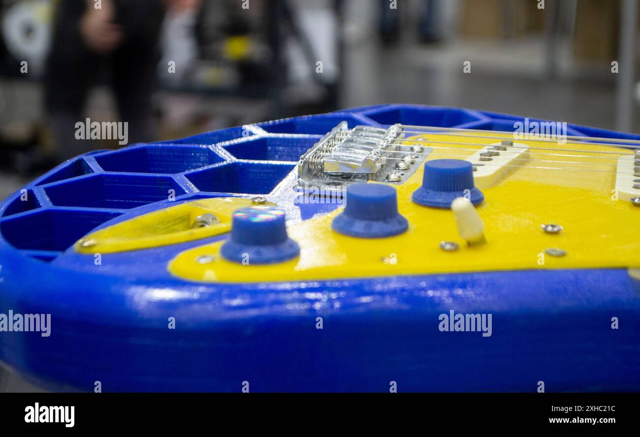 Musical instrument guitar 3D printed from molten plastic in yellow and ...