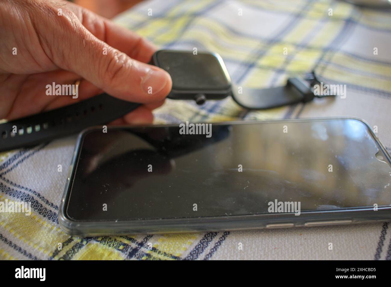 human hand manipulating smartwatch and smartphone Stock Photo - Alamy