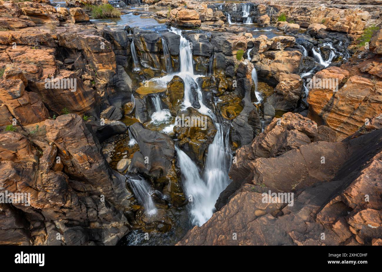 Waterfalls between orange-coloured rocks on the Treur River, Bourke's ...