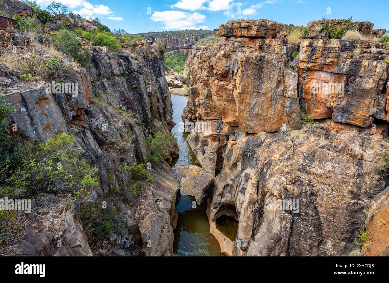 Bridge over a canyon with steep orange-coloured cliffs and the Blyde ...