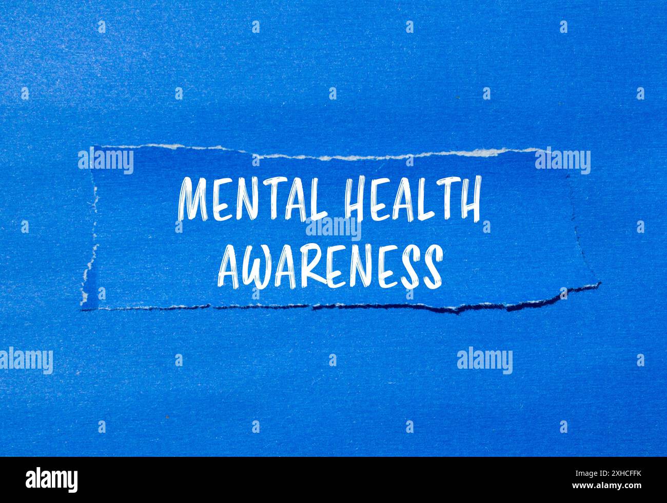 Mental health awareness message written on ripped paper piece with blue ...