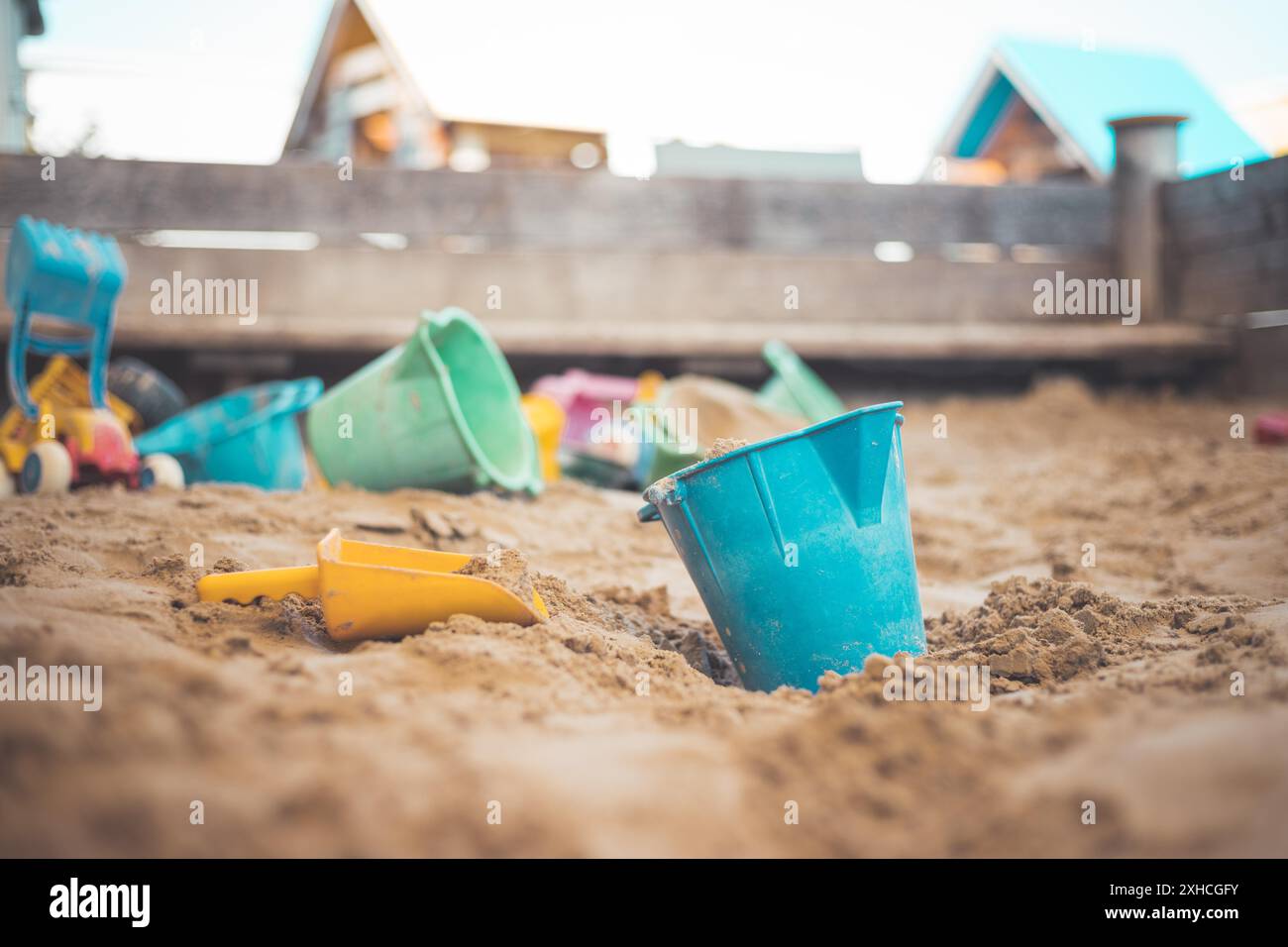 Children plastic toys in the sand box. Dirt bucket, selective focus ...