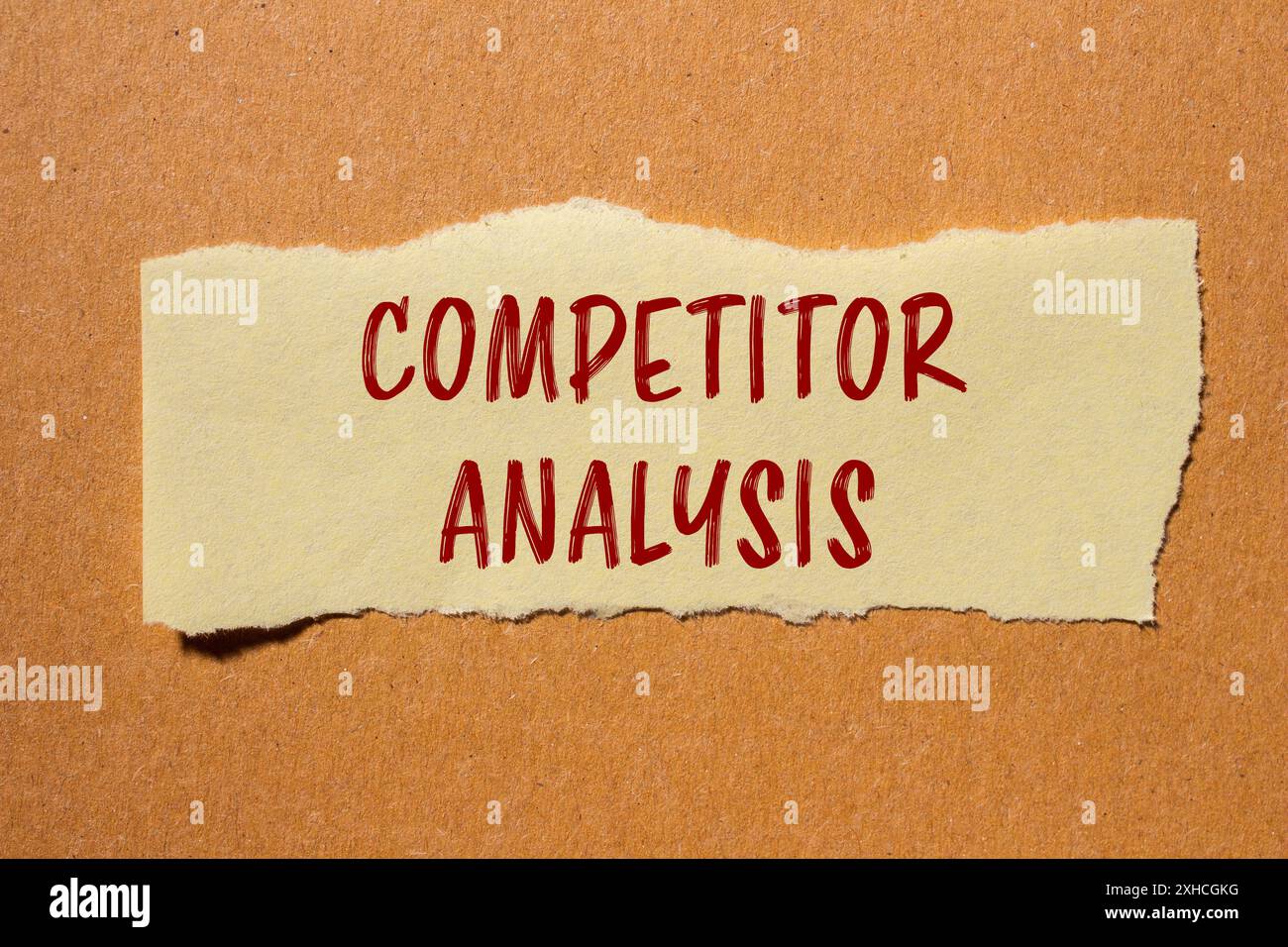 Competitor analysis message written on ripped paper piece with ...