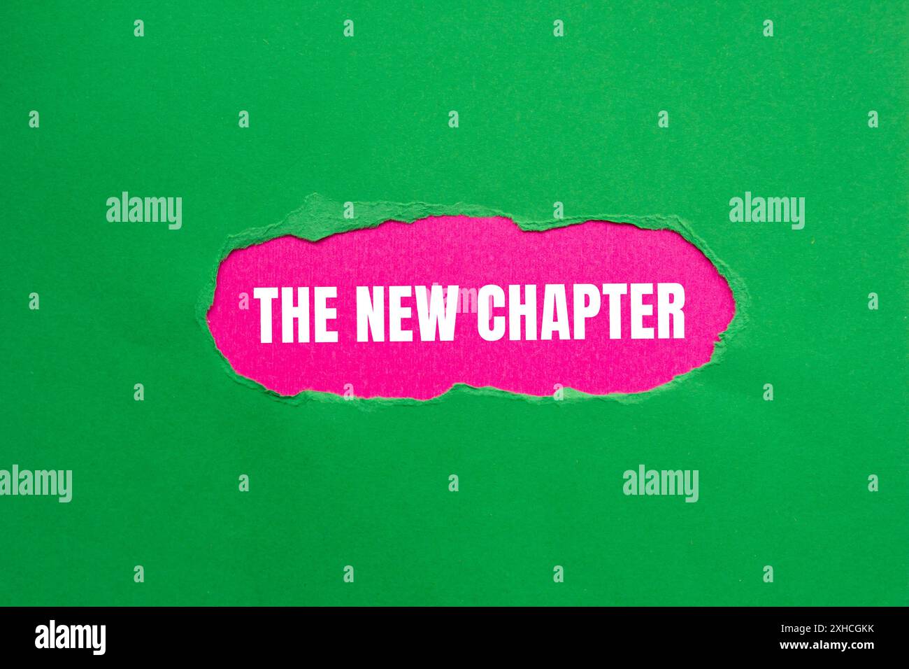 The new chapter message written on ripped green paper with pink background. Conceptual the new ...