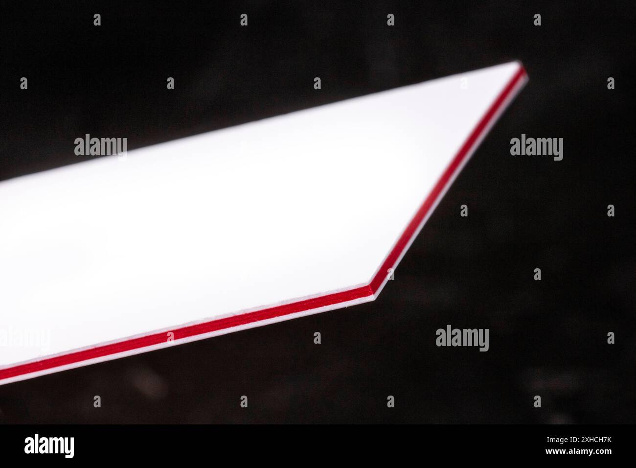 White and red 3-ply thick stock business cards, floating on a black ...