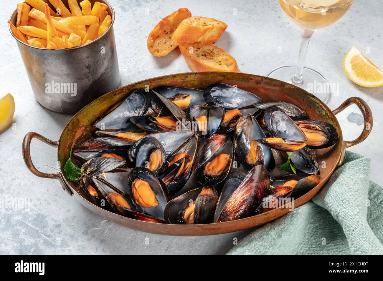 Mussels dinner with wine, French fries, and toasted bread Stock Photo ...