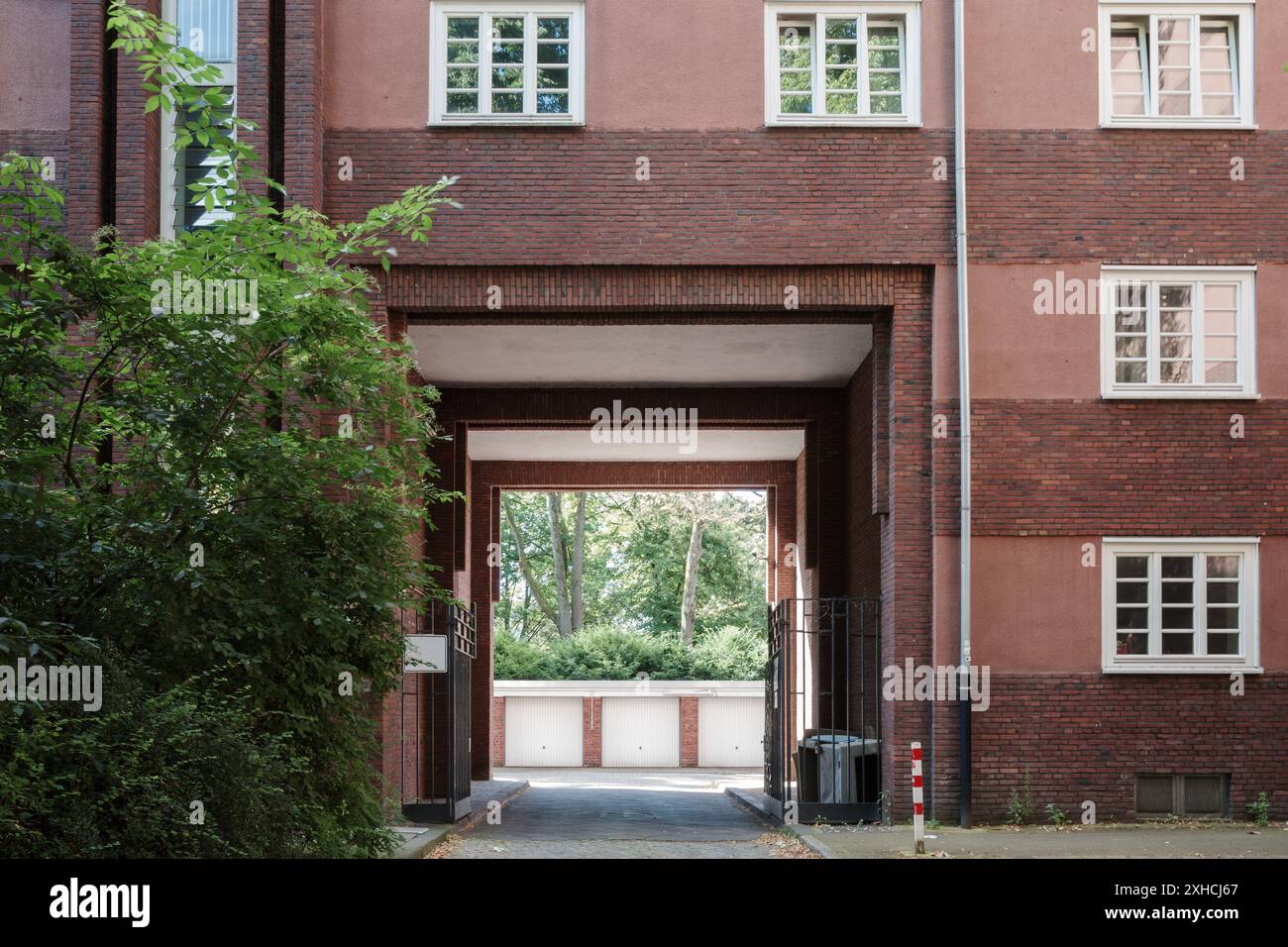 The facade of a brick building featuring symmetrical windows with white ...