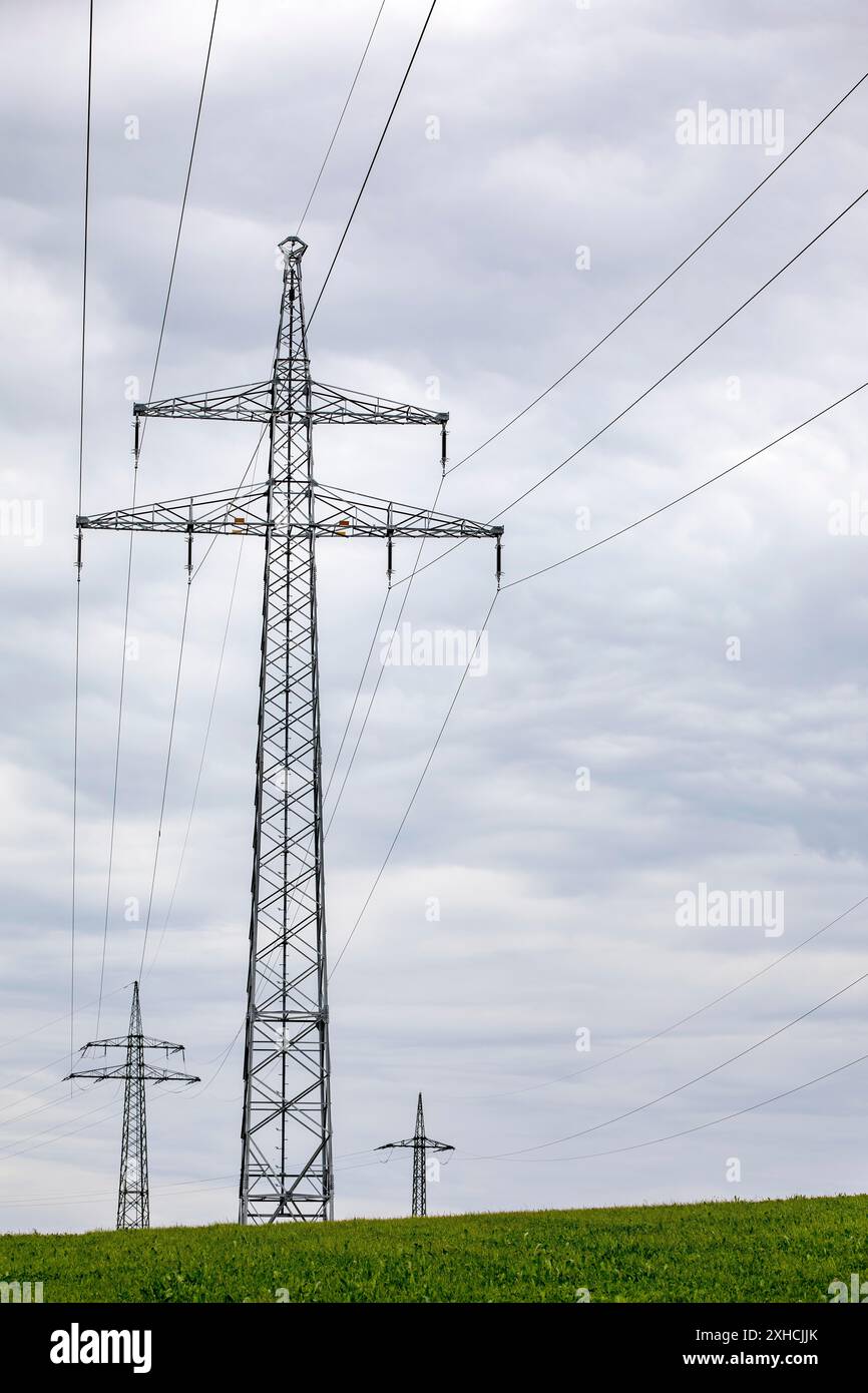 Electricity pylon with cables in a dramatic sky Stock Photo - Alamy