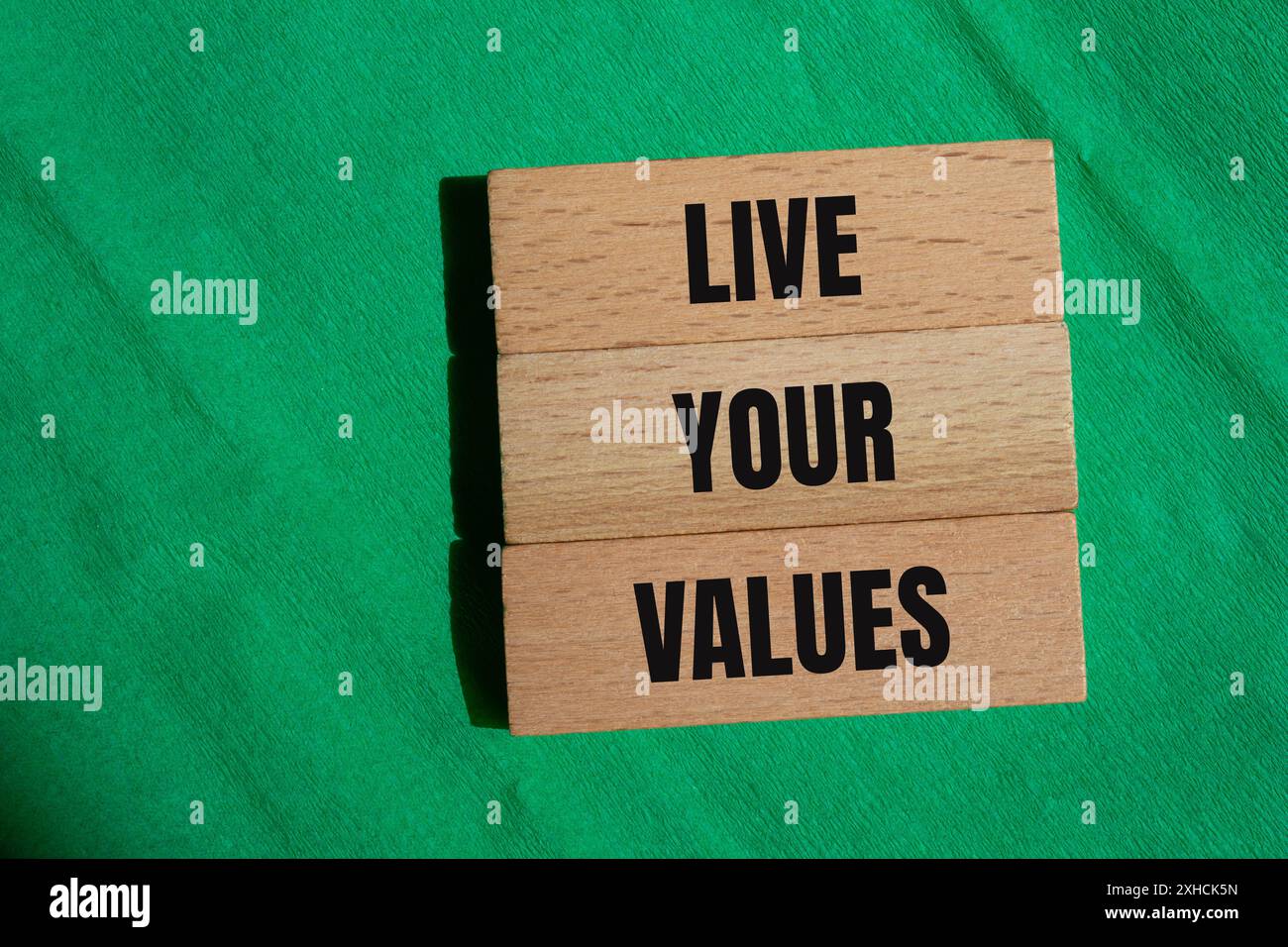 Live your values words written on wooden blocks with green background ...