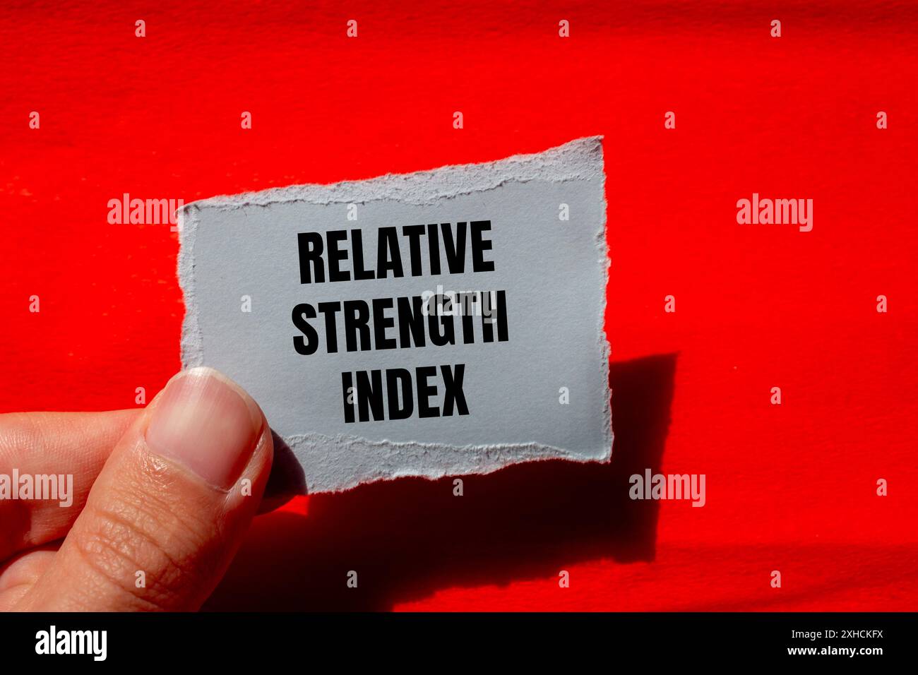 Relative strength index message written on ripped paper piece with red ...