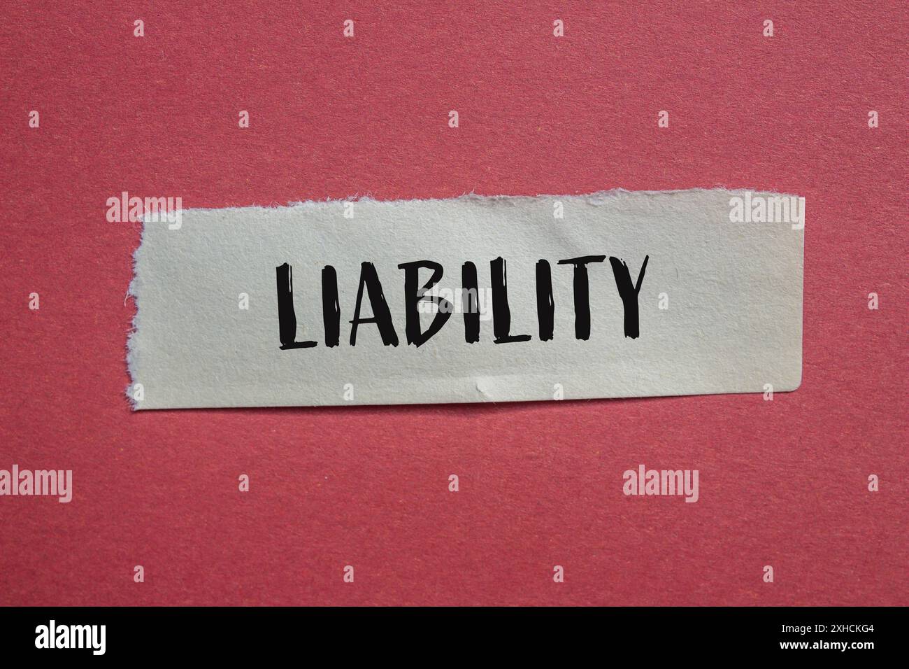 Liability message written on ripped paper with red background ...