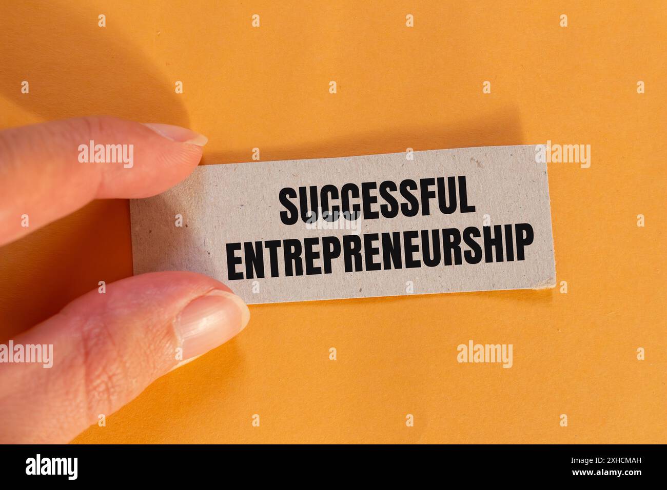 Successful entrepreneurship message written on ripped paper piece with ...