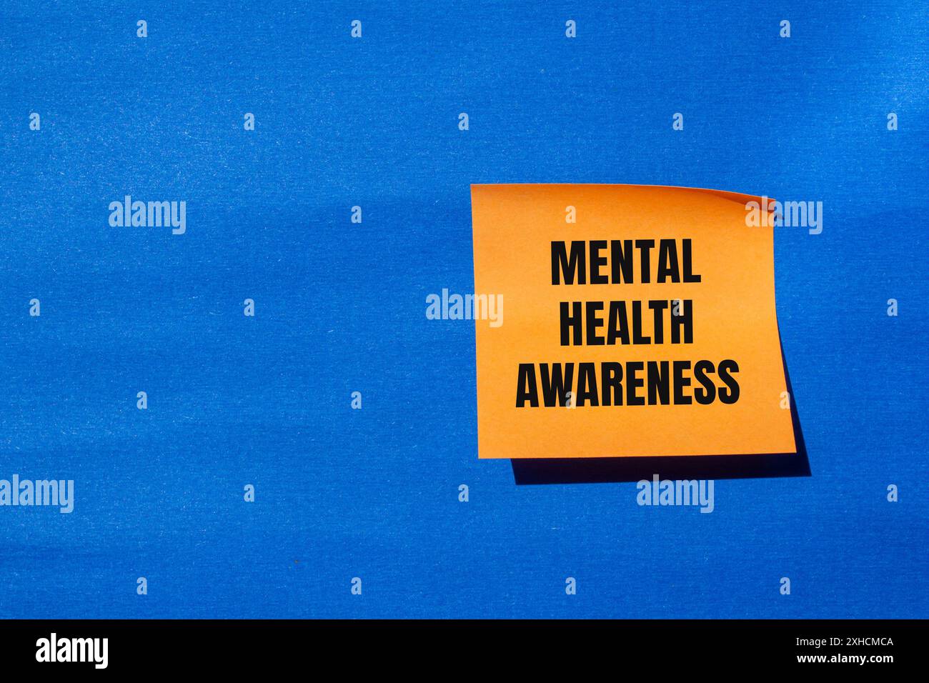 Mental health awareness message written on orange paper with blue ...