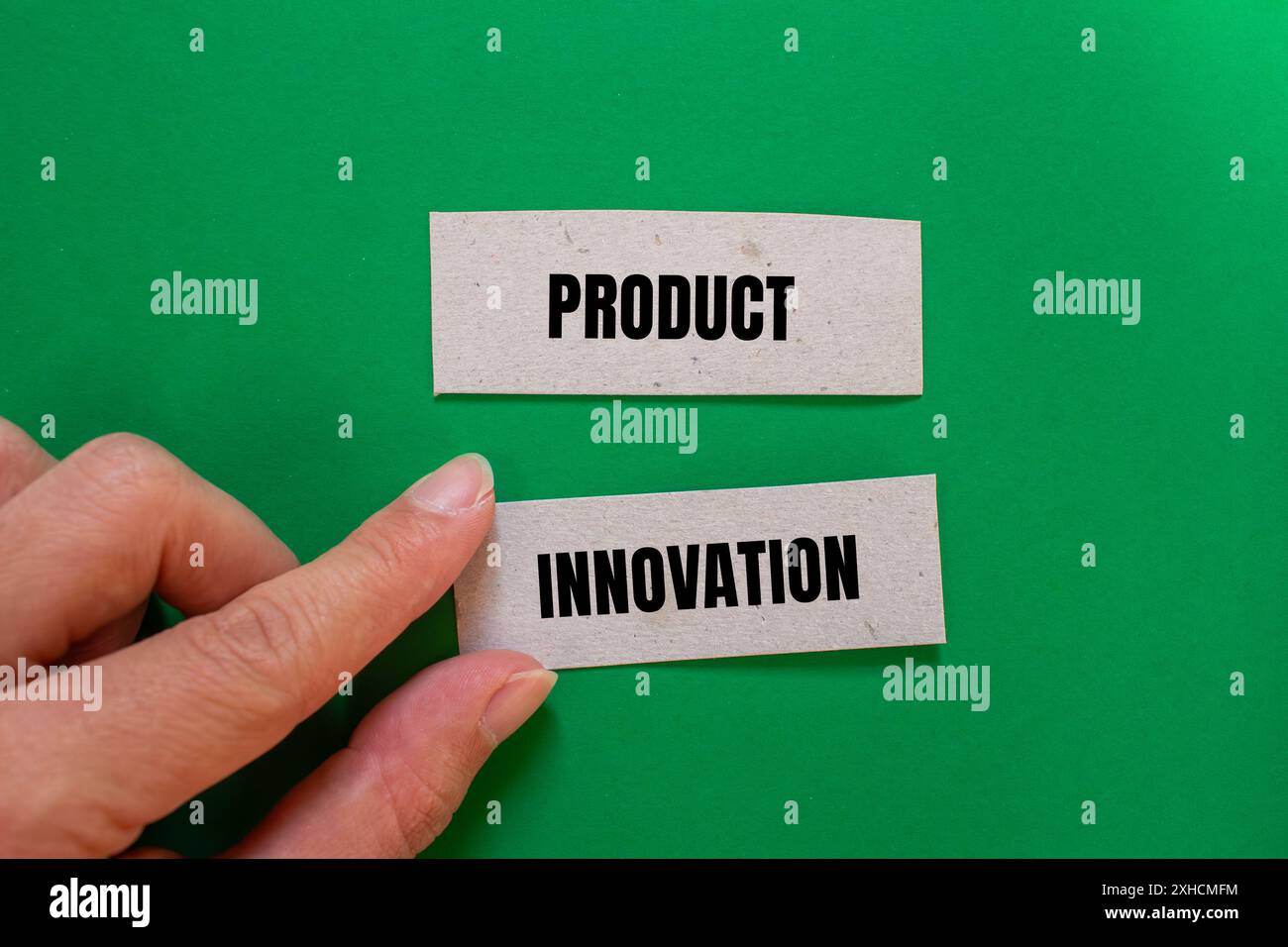 Product innovation message written on paper pieces with green ...