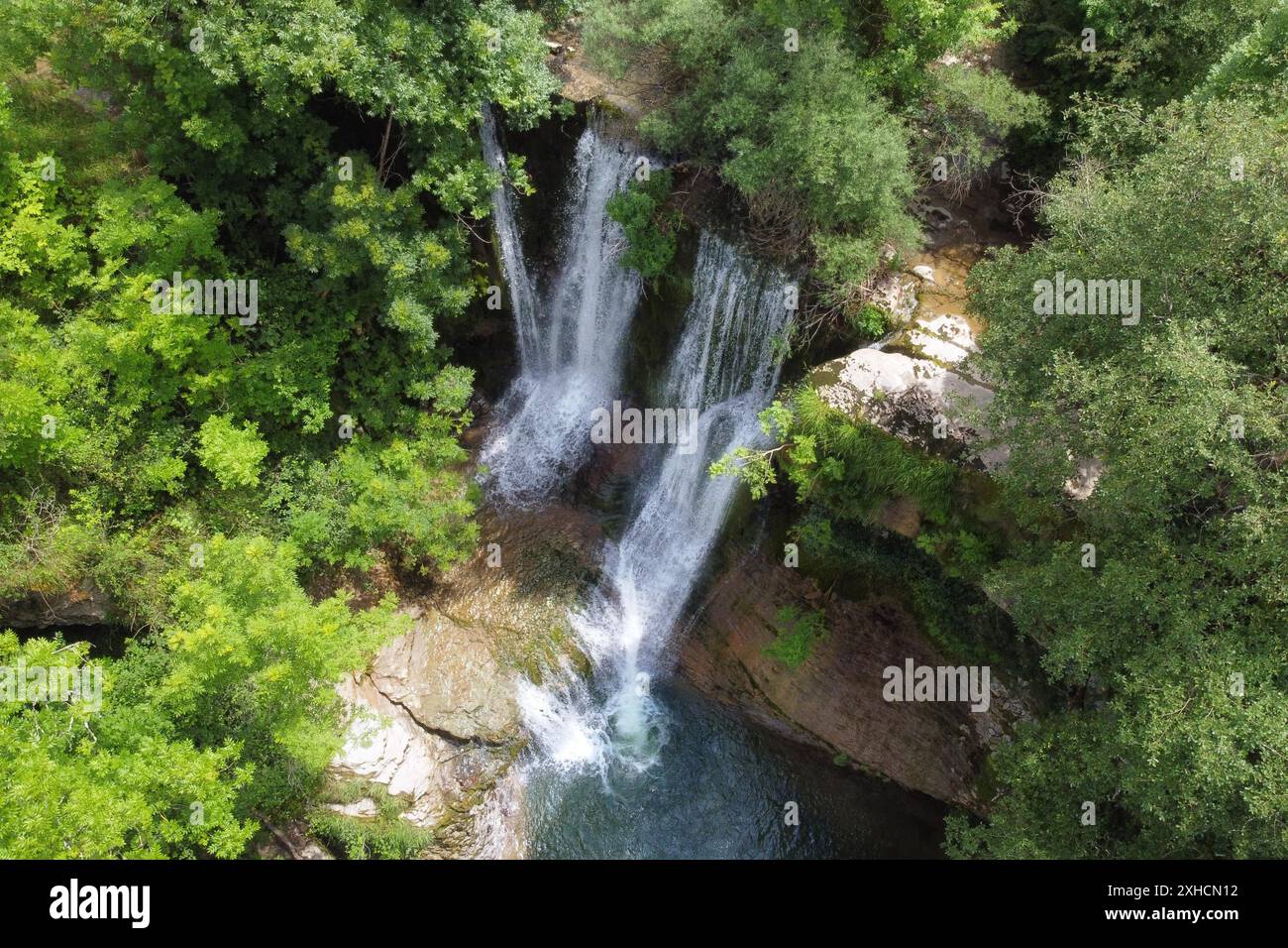 Aerial view of an Idyllic rain forest waterfall, stream flowing in the ...
