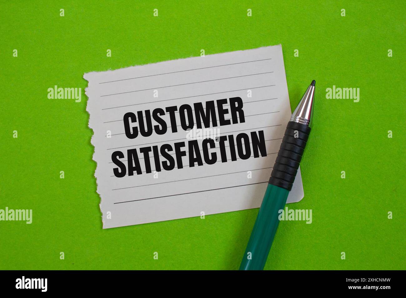 Customer satisfaction message written on ripped paper piece with ...