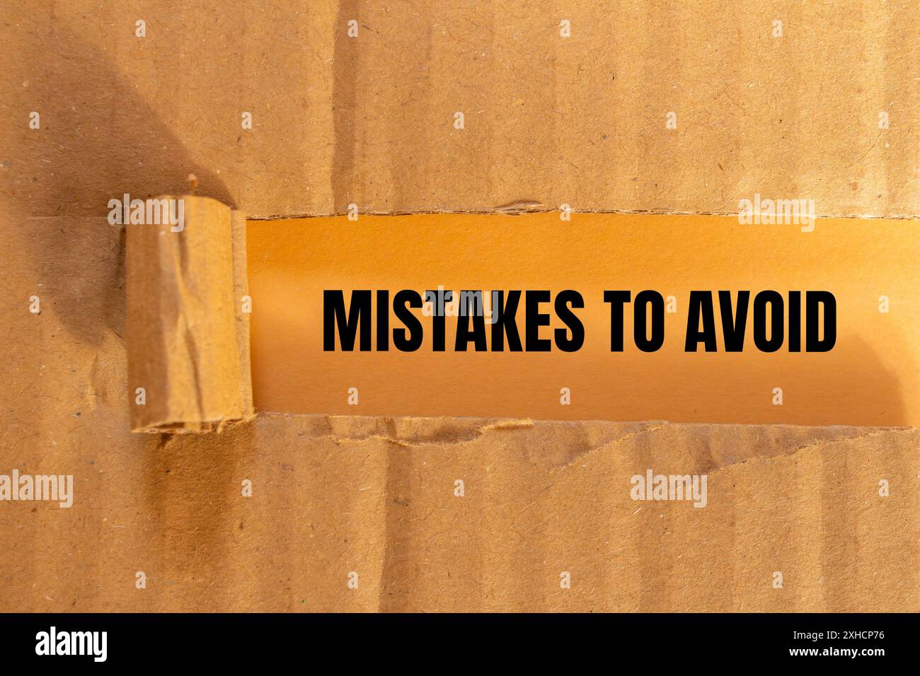 Mistakes to avoid message written on ripped paper with color background ...