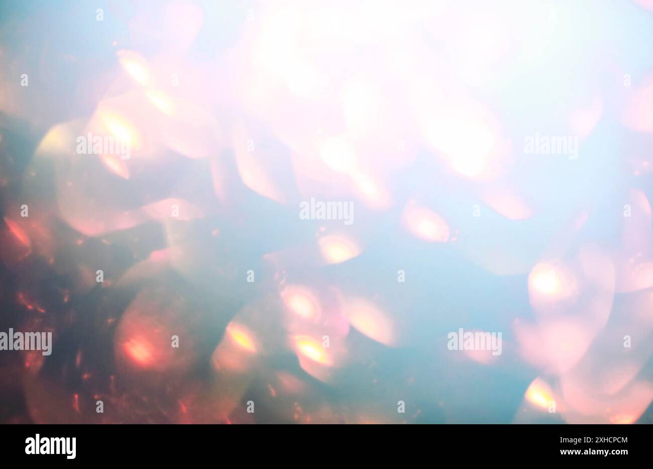 Abstract background of bright spots of lights shining with pink and ...